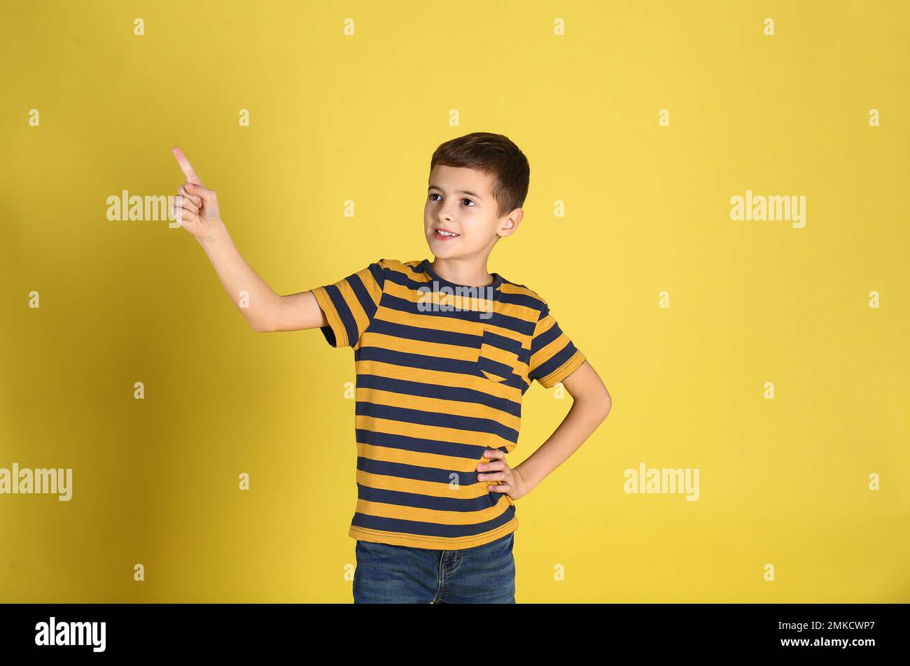 Portrait of cute little boy on yellow background Stock Photo - Alamy
