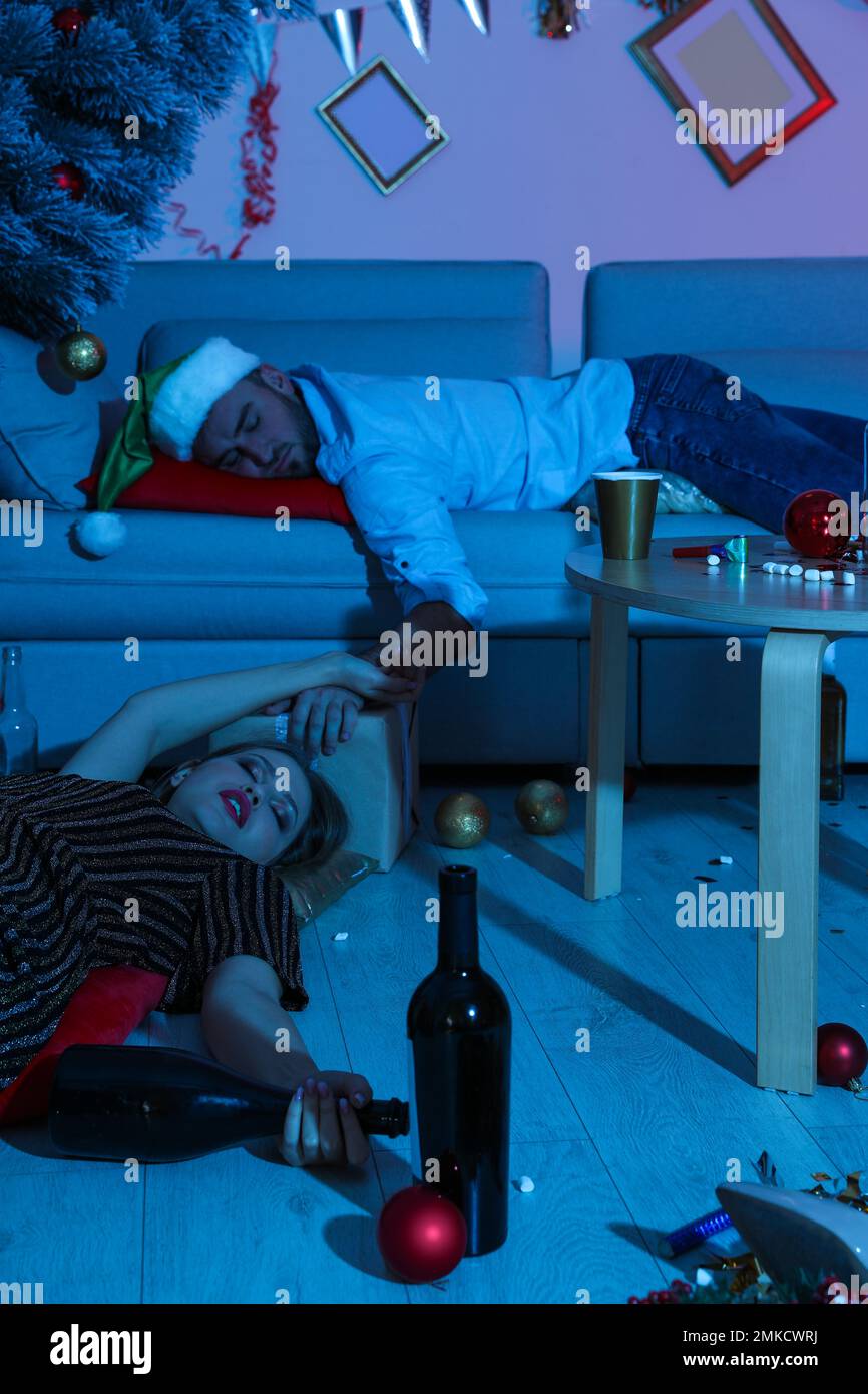 Drunk friends sleeping in messy room after New Year party Stock Photo ...