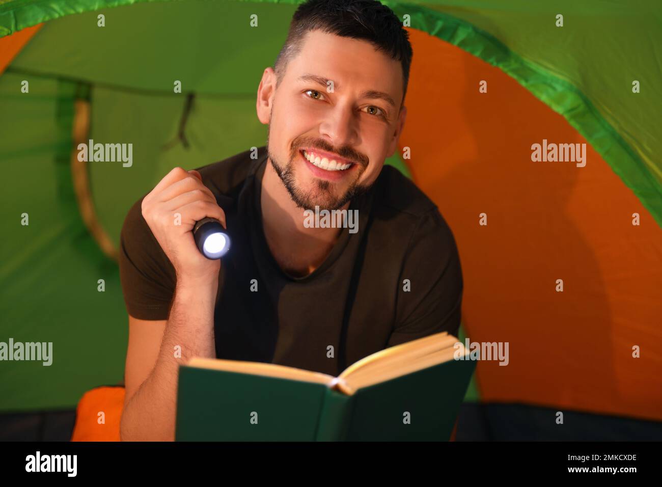 Man flashlight reading book hi-res stock photography and images - Alamy