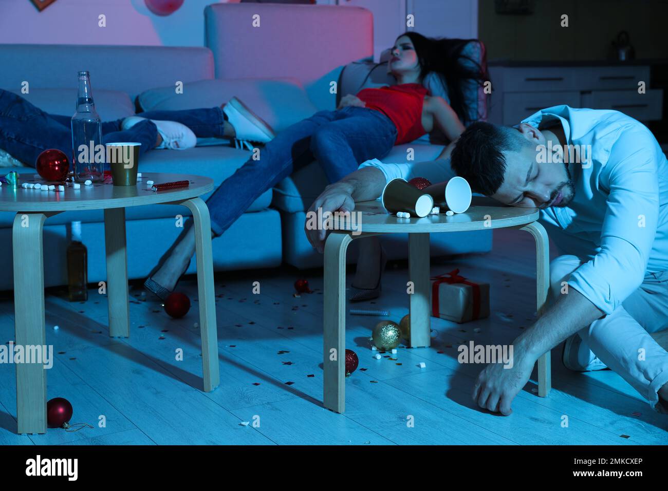 Drunk friends sleeping in messy room after New Year party Stock Photo ...