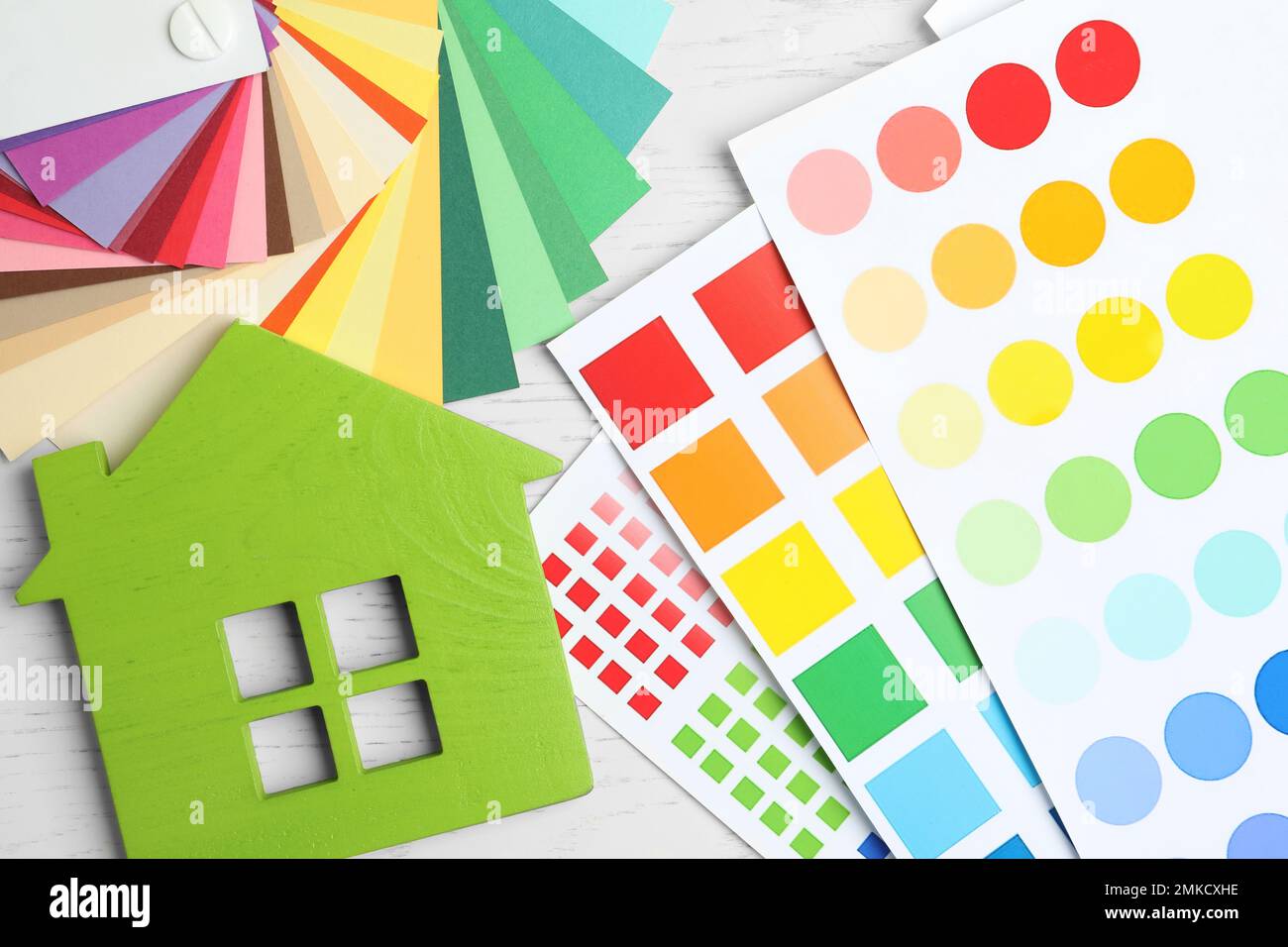 Flat lay composition with color palettes on white wooden background ...
