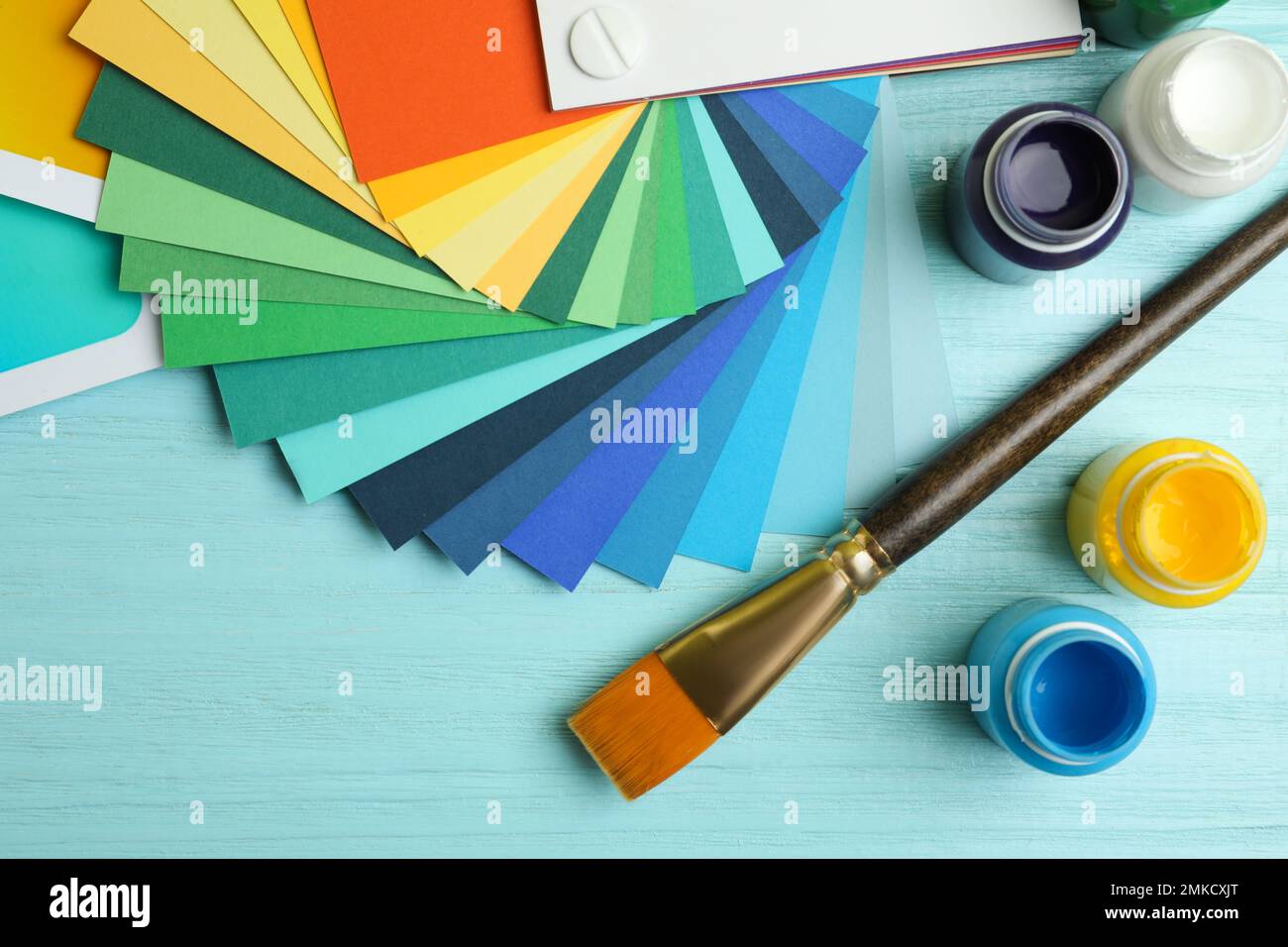 Flat lay composition with color palettes on light blue wooden ...