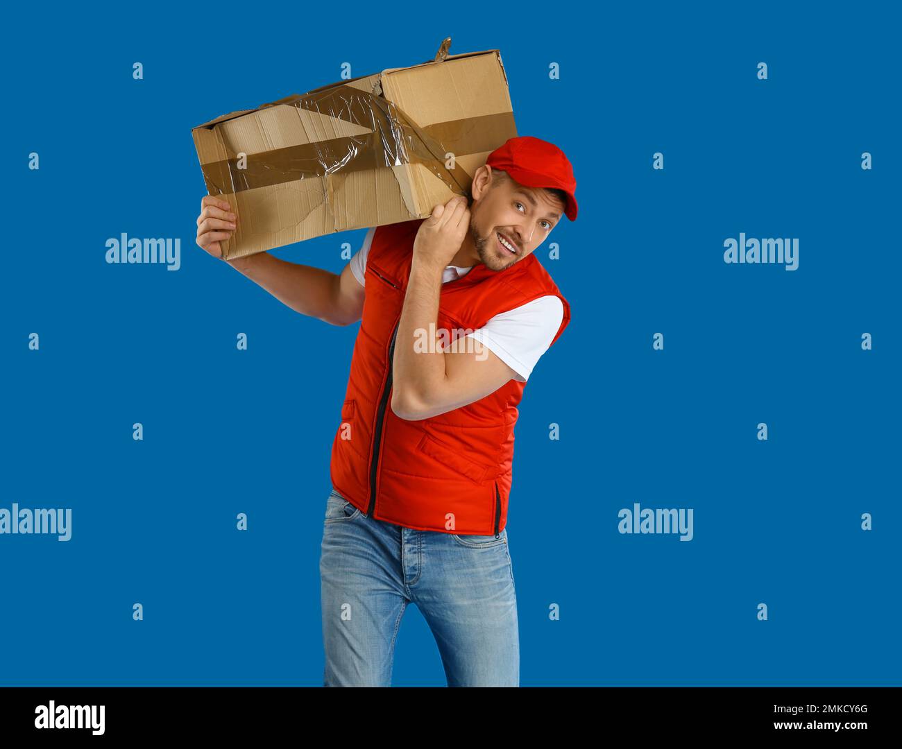 Courier with damaged cardboard box on blue background. Poor quality ...