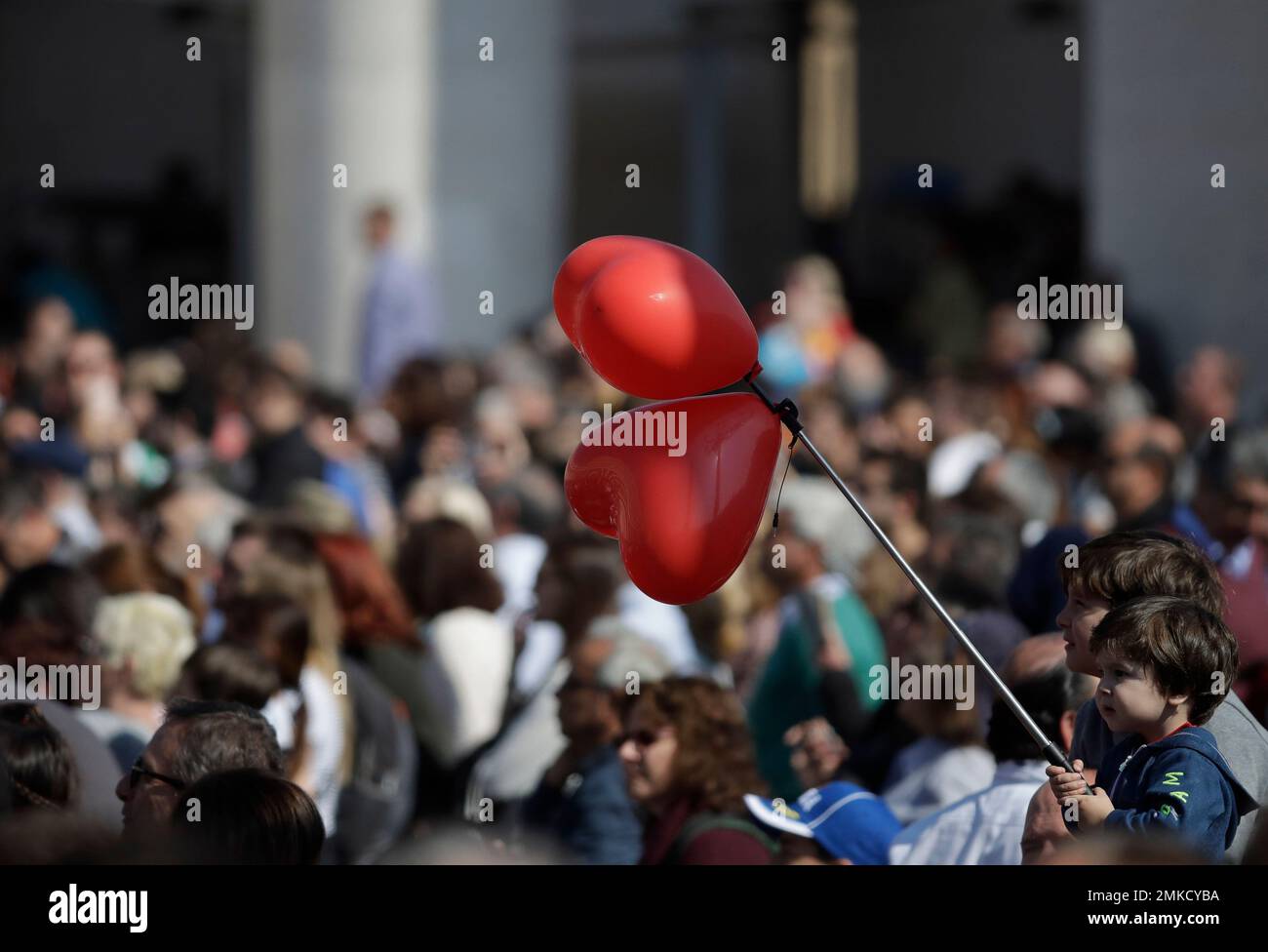 A child hods heart shaped balloons during the Angelus noon prayer ...