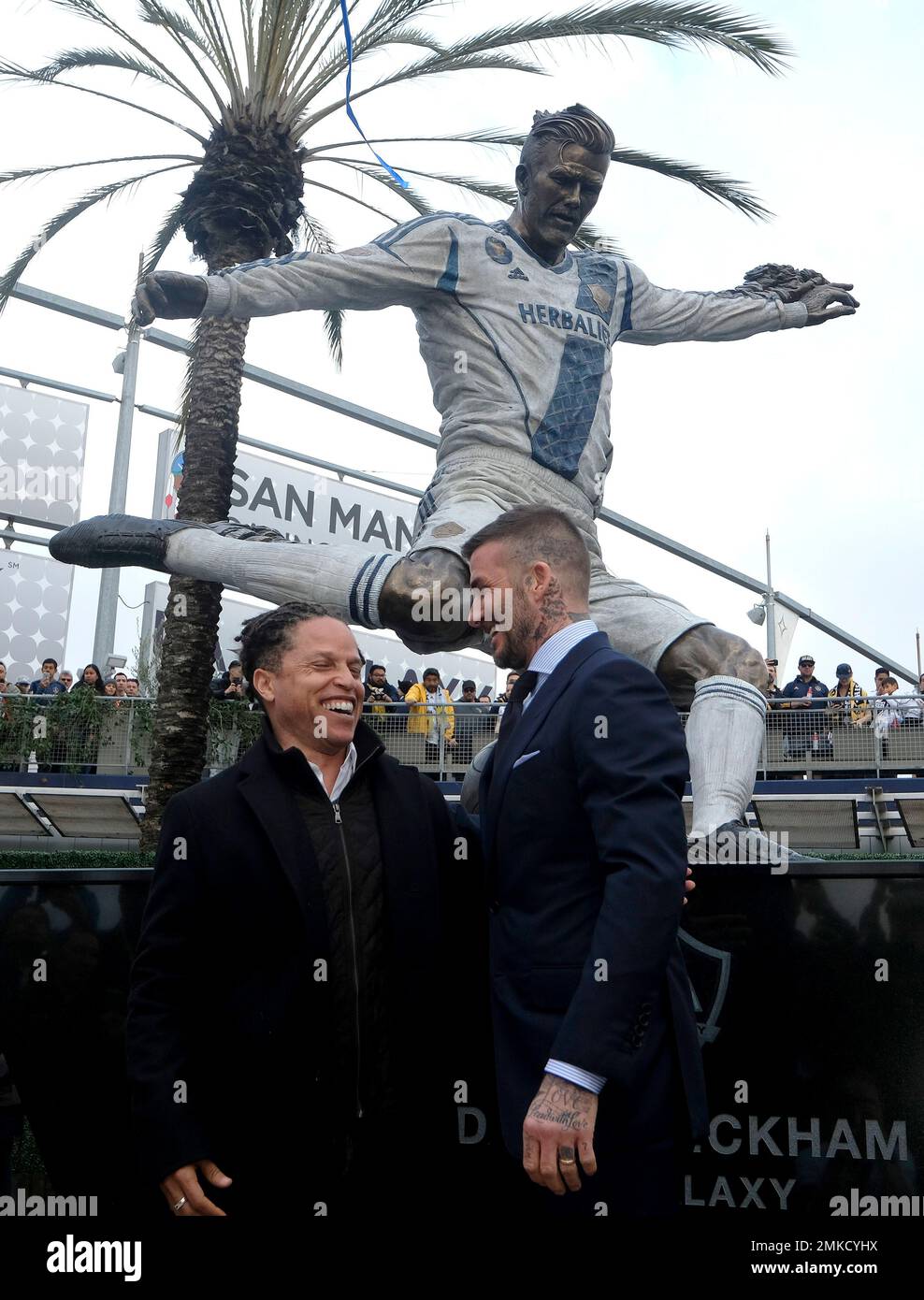 Cobi Jones, left, and David Beckham pose with the newly unveiled statue ...