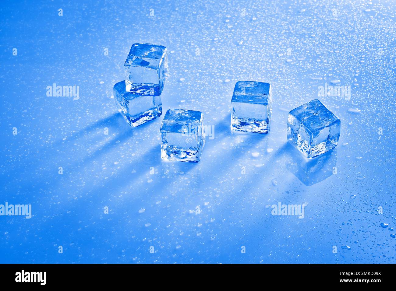 Cold ice cubes on reflective surface with water drops Stock Photo - Alamy