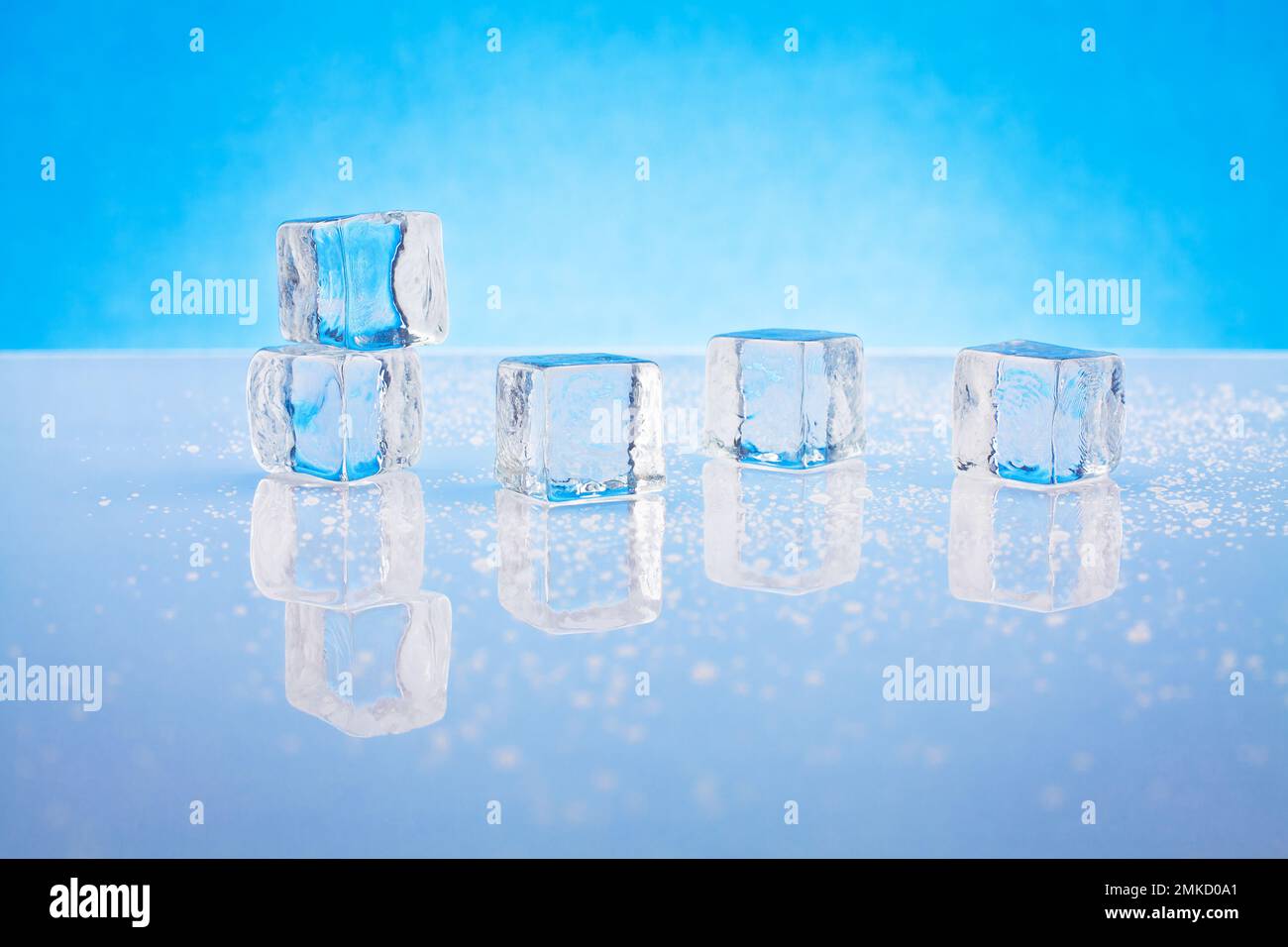 Cold ice cubes on reflective surface with water drops Stock Photo - Alamy
