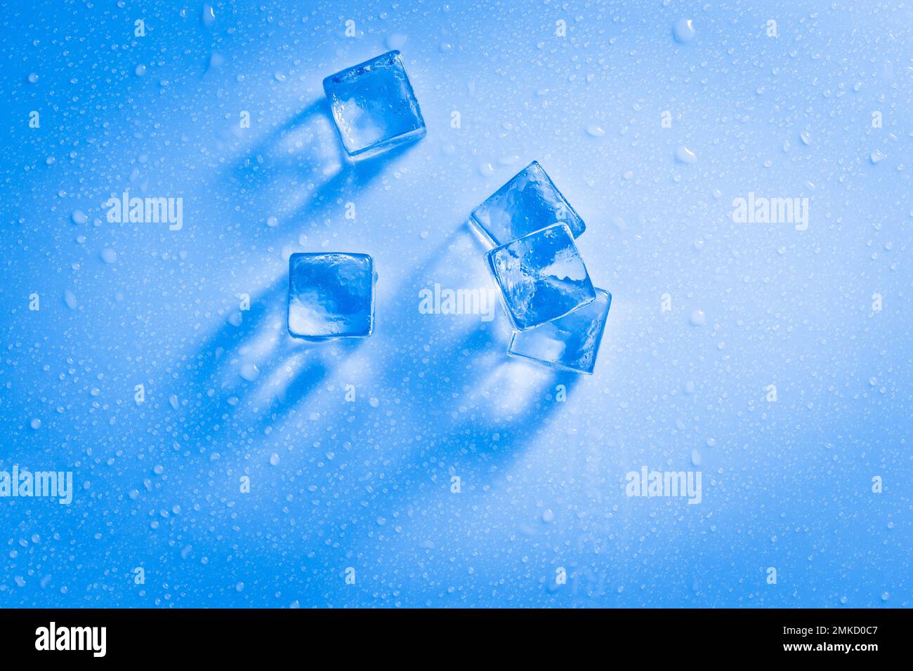 Cold ice cubes on reflective surface with water drops Stock Photo - Alamy