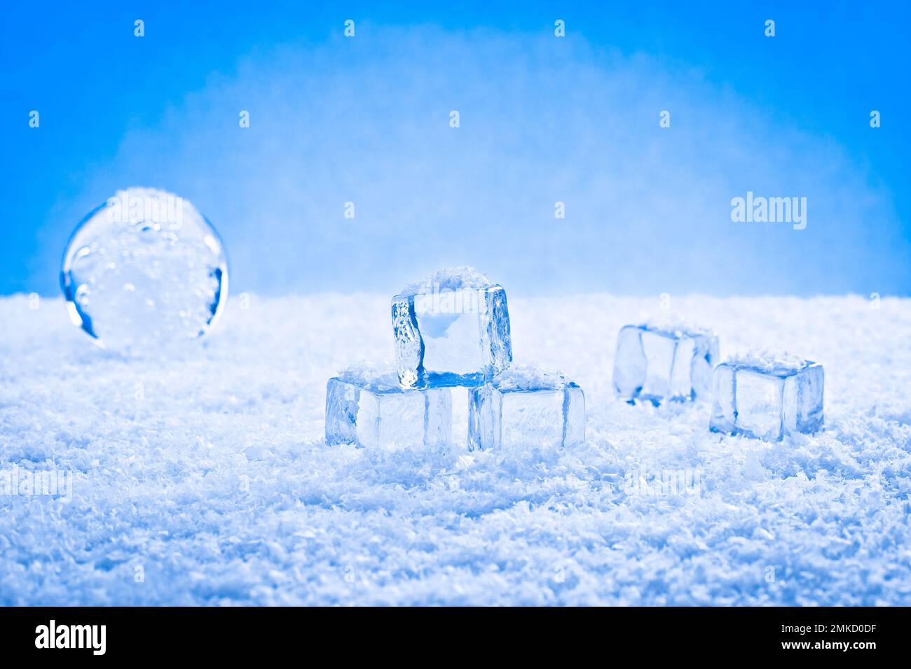 Ice cubes and a crystal ball, above the snow Stock Photo - Alamy