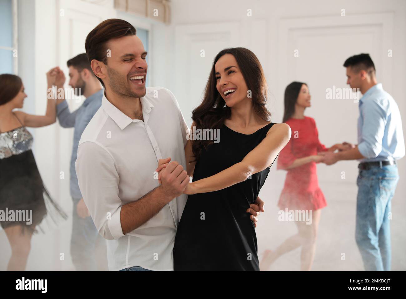Lovely young couple dancing together at party Stock Photo - Alamy