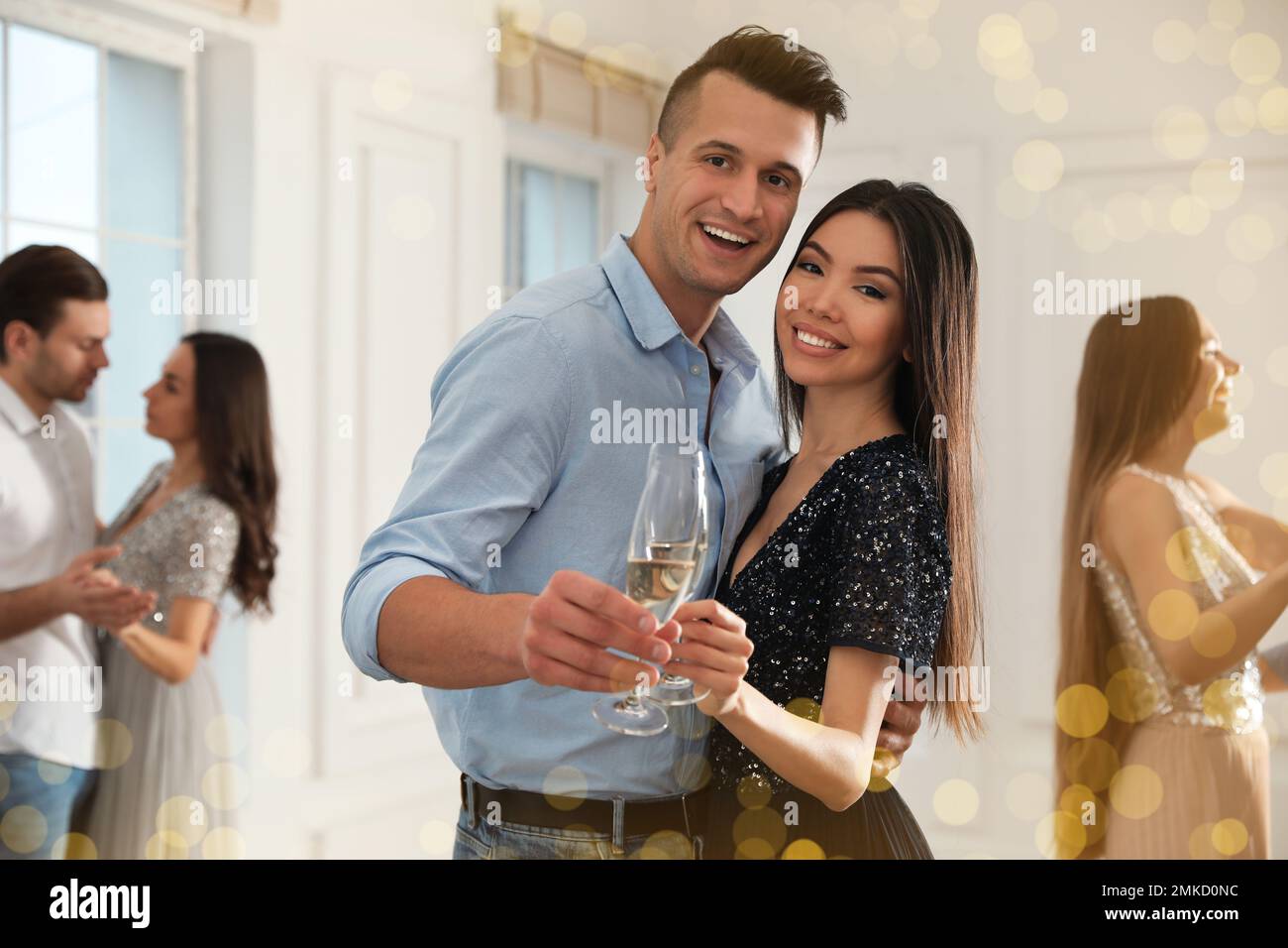 Lovely young couple with glasses of champagne at dancing party Stock ...