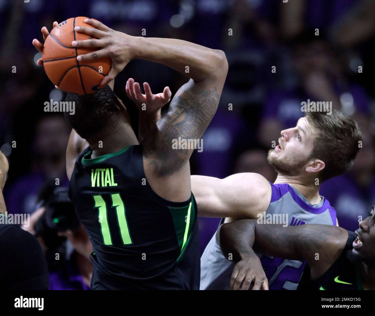 Kansas State forward Dean Wade, right, reaches inagainst Baylor guard ...