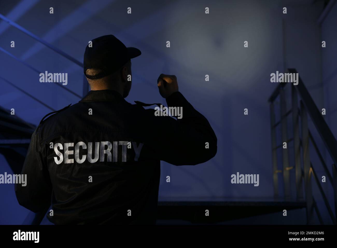 Male security guard with flashlight on stairs in darkness Stock Photo ...