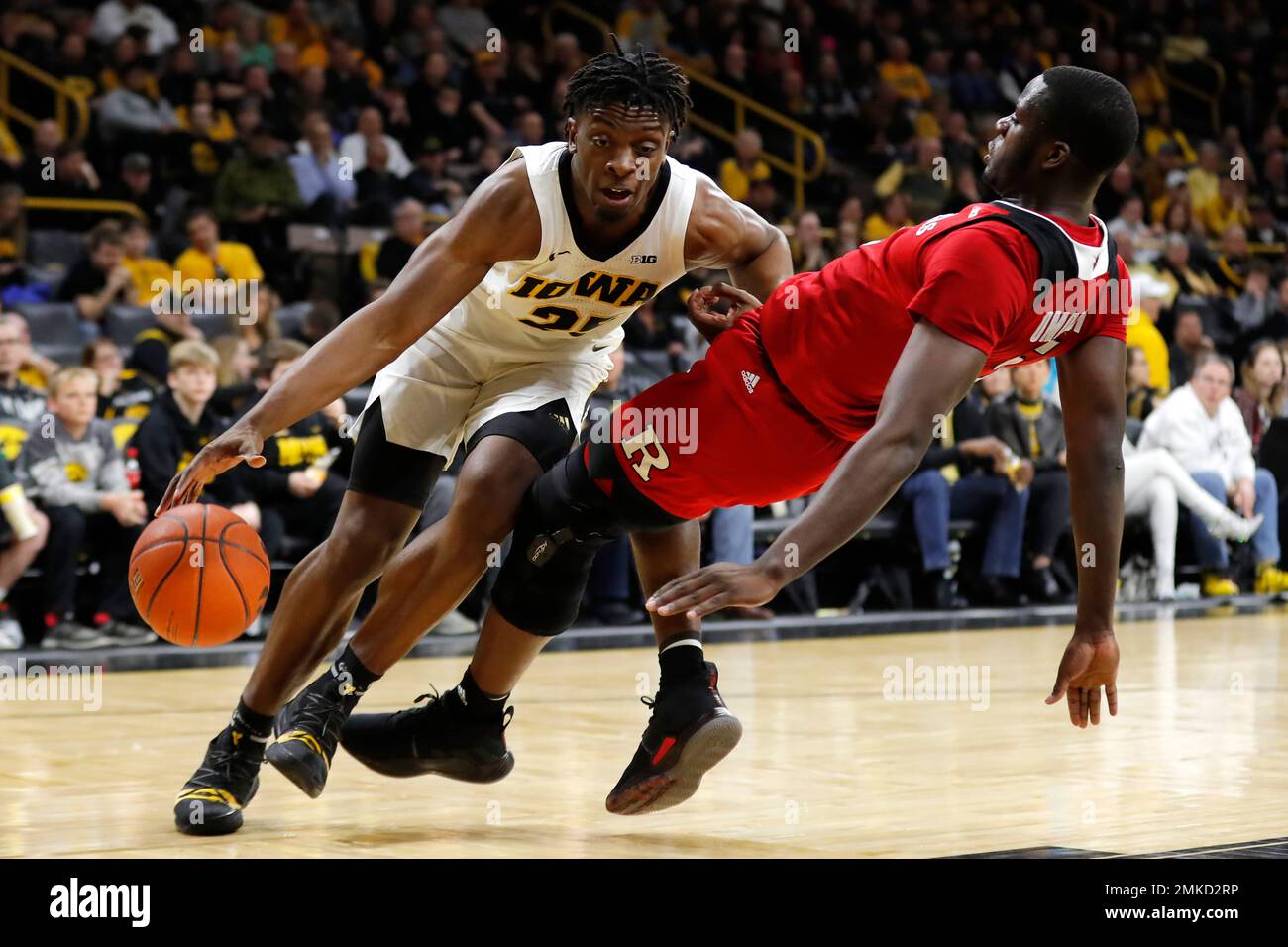 Iowa forward Tyler Cook is fouled by Rutgers forward Eugene Omoruyi ...