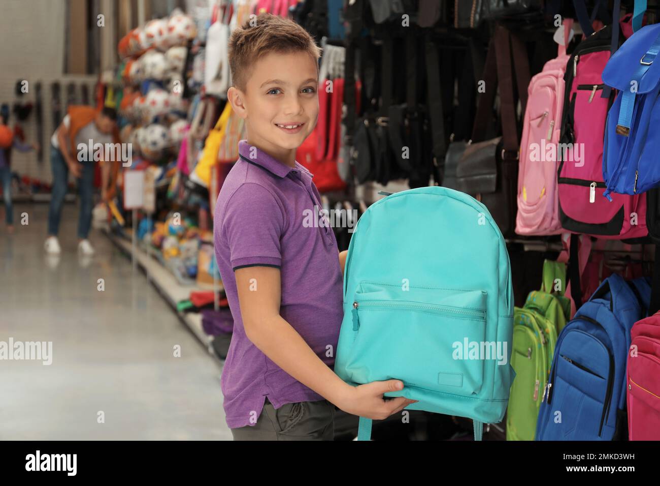 Little school boy with backpack in supermarket Stock Photo - Alamy