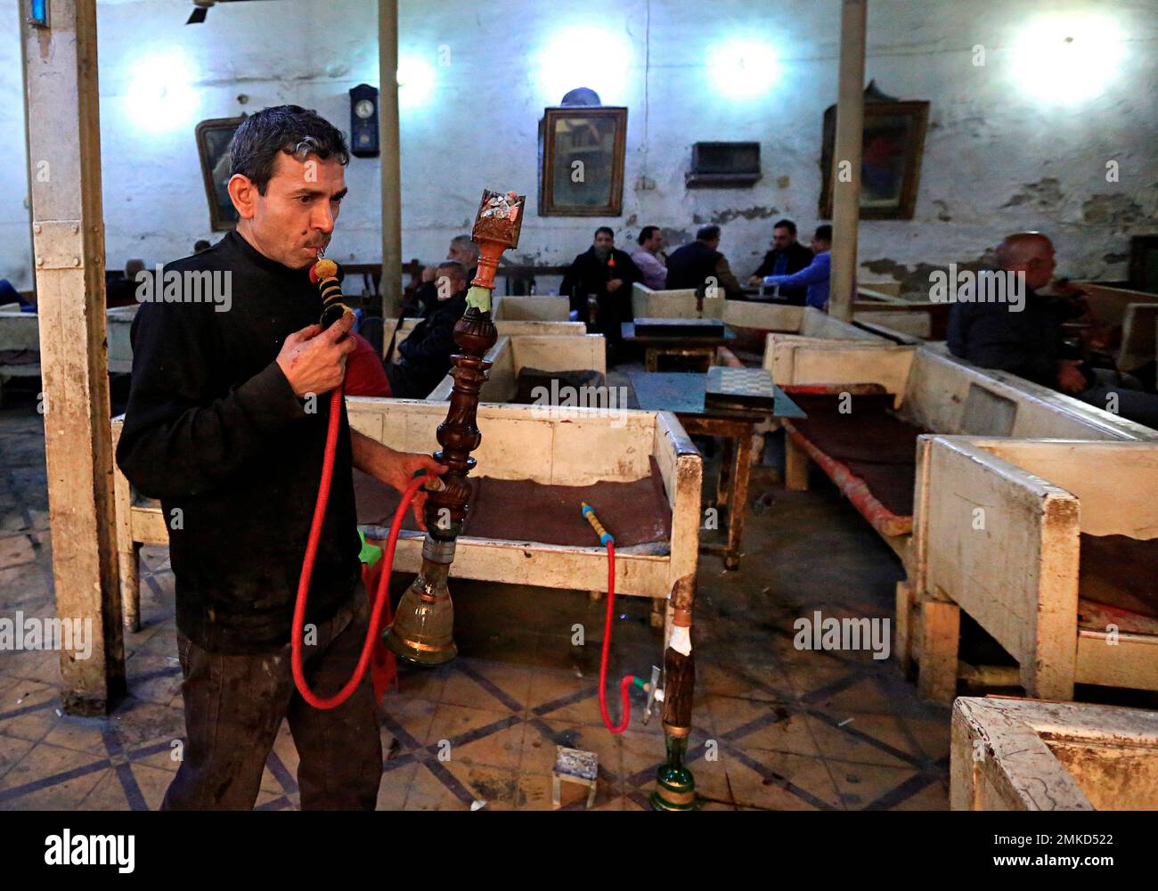 A worker prepares shisha or water pipe for customers at Hassan Ajami ...
