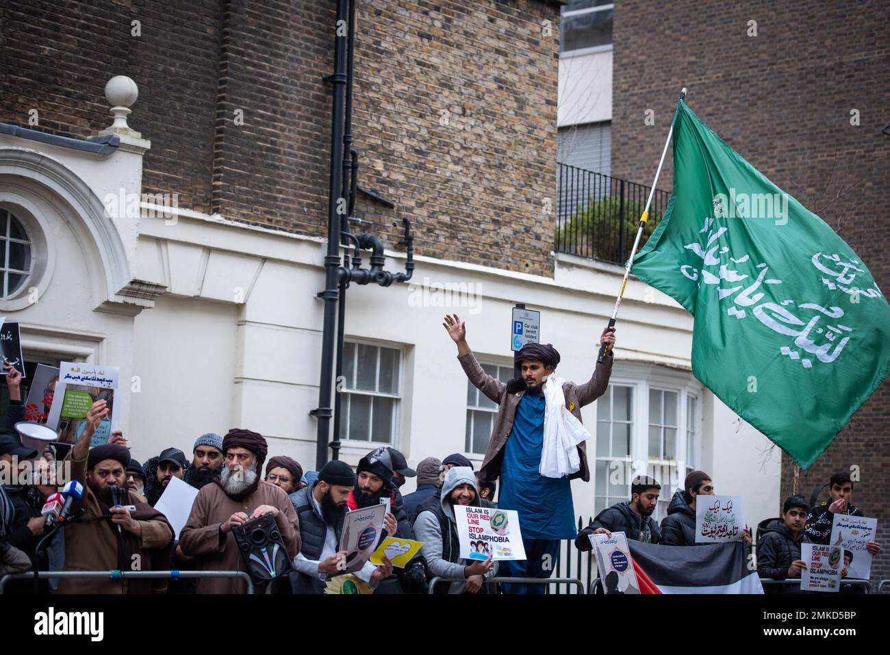 A protestor waves a flag outside the Sweden Embassy of London during ...