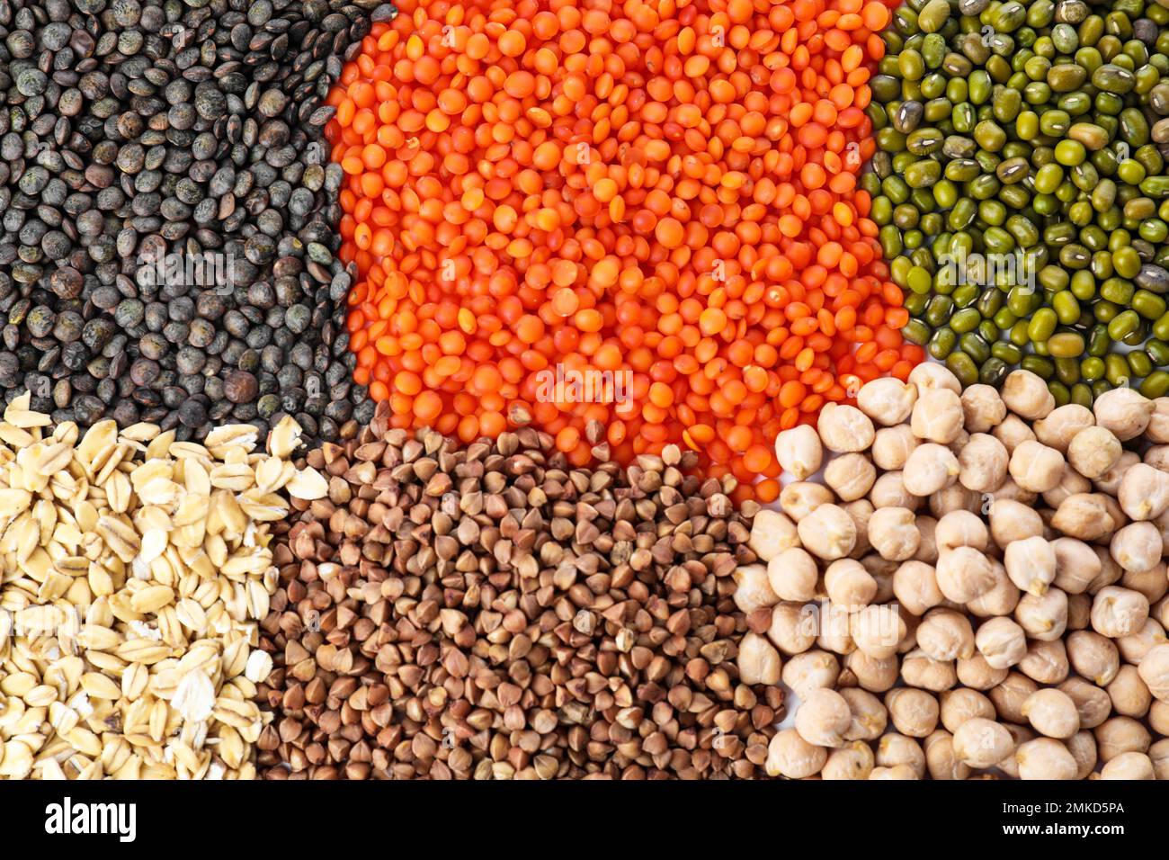 Different grains and cereals as background, top view Stock Photo - Alamy