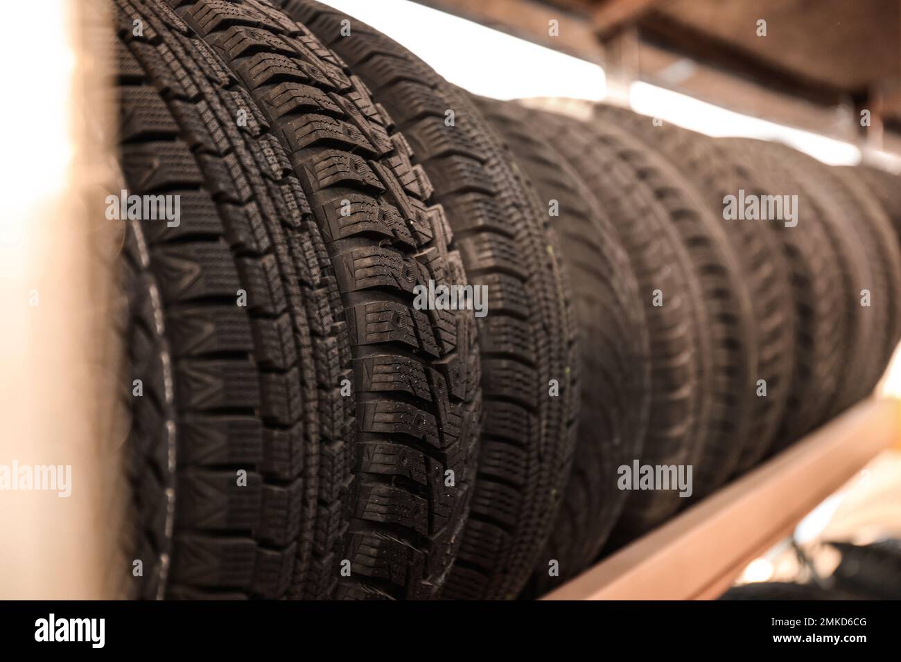 Row of tires on rack in store. Total wholesale Stock Photo - Alamy