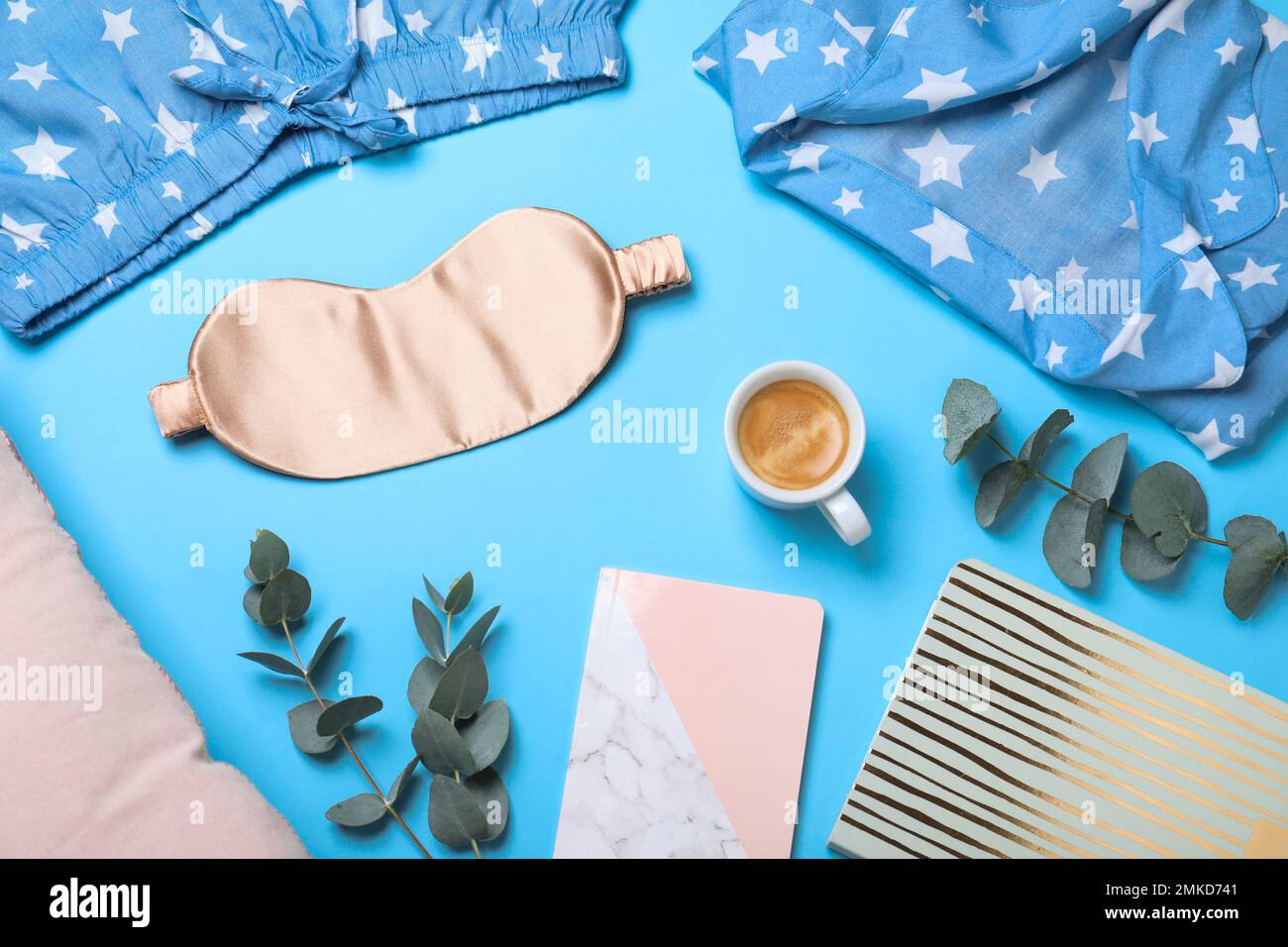 Flat lay composition with sleeping mask on light blue background ...