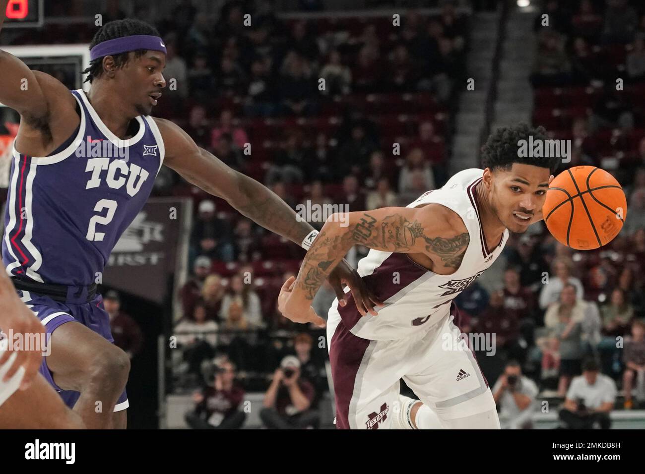 Mississippi State guard Shakeel Moore, right, dribbles past TCU forward ...