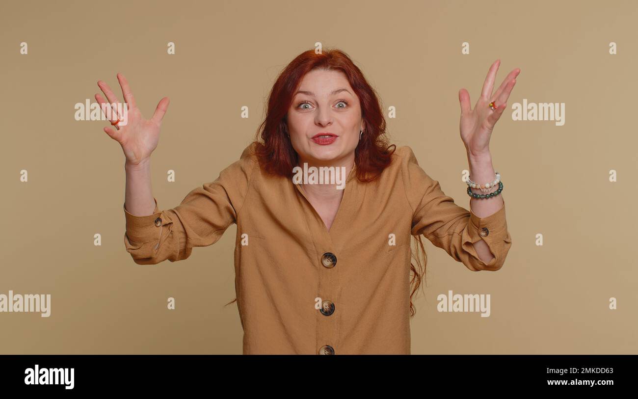Excited Amazed Redhead Woman In Blouse Touching Head And Showing