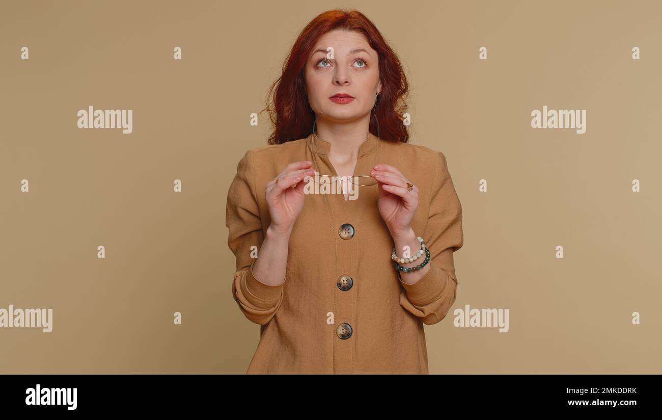 Exhausted tired redhead woman takes off glasses, feels eyes pain, being ...