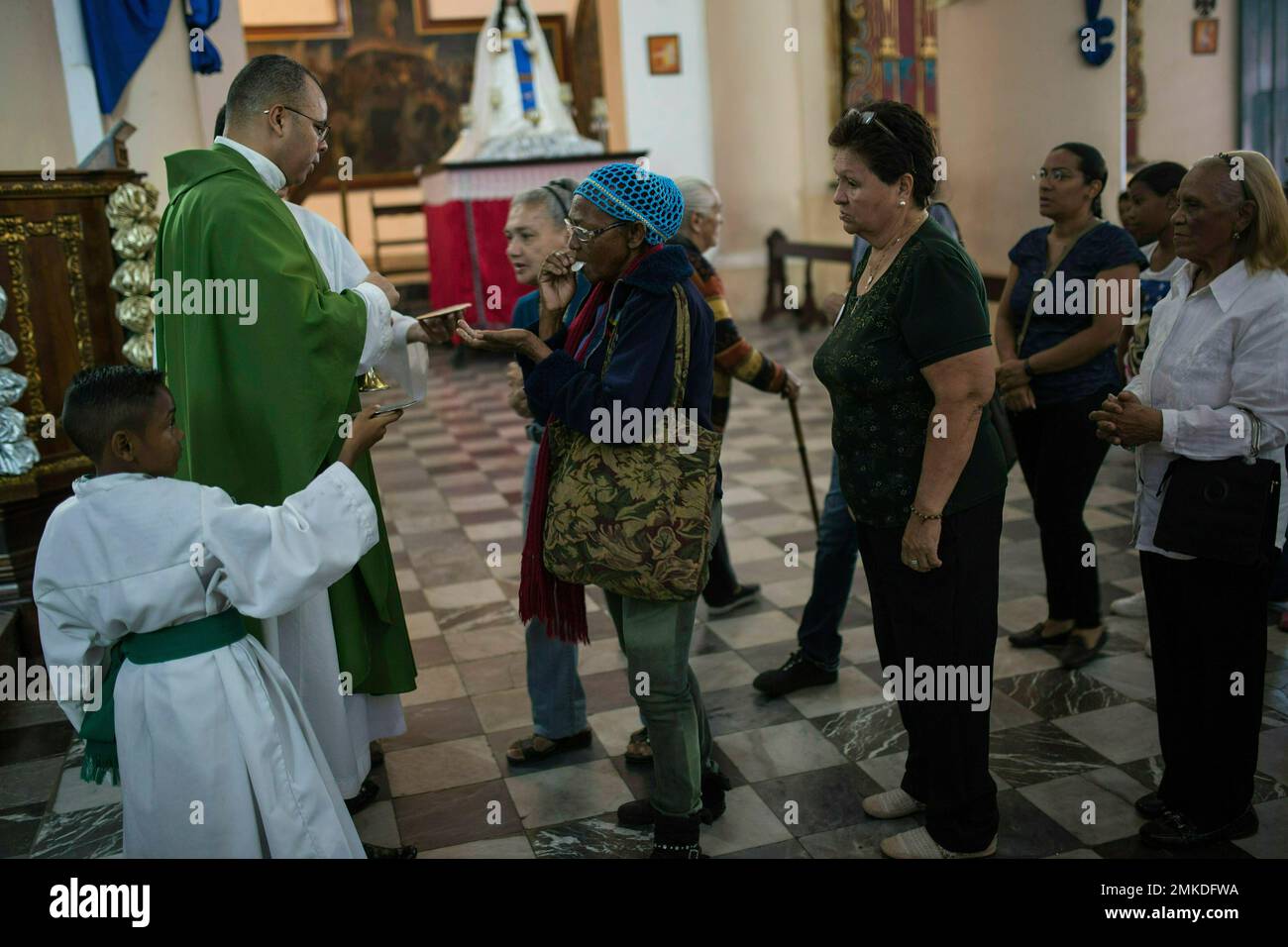 In this Feb. 9, 2019 photo, faithful receive Holy Communion from ...