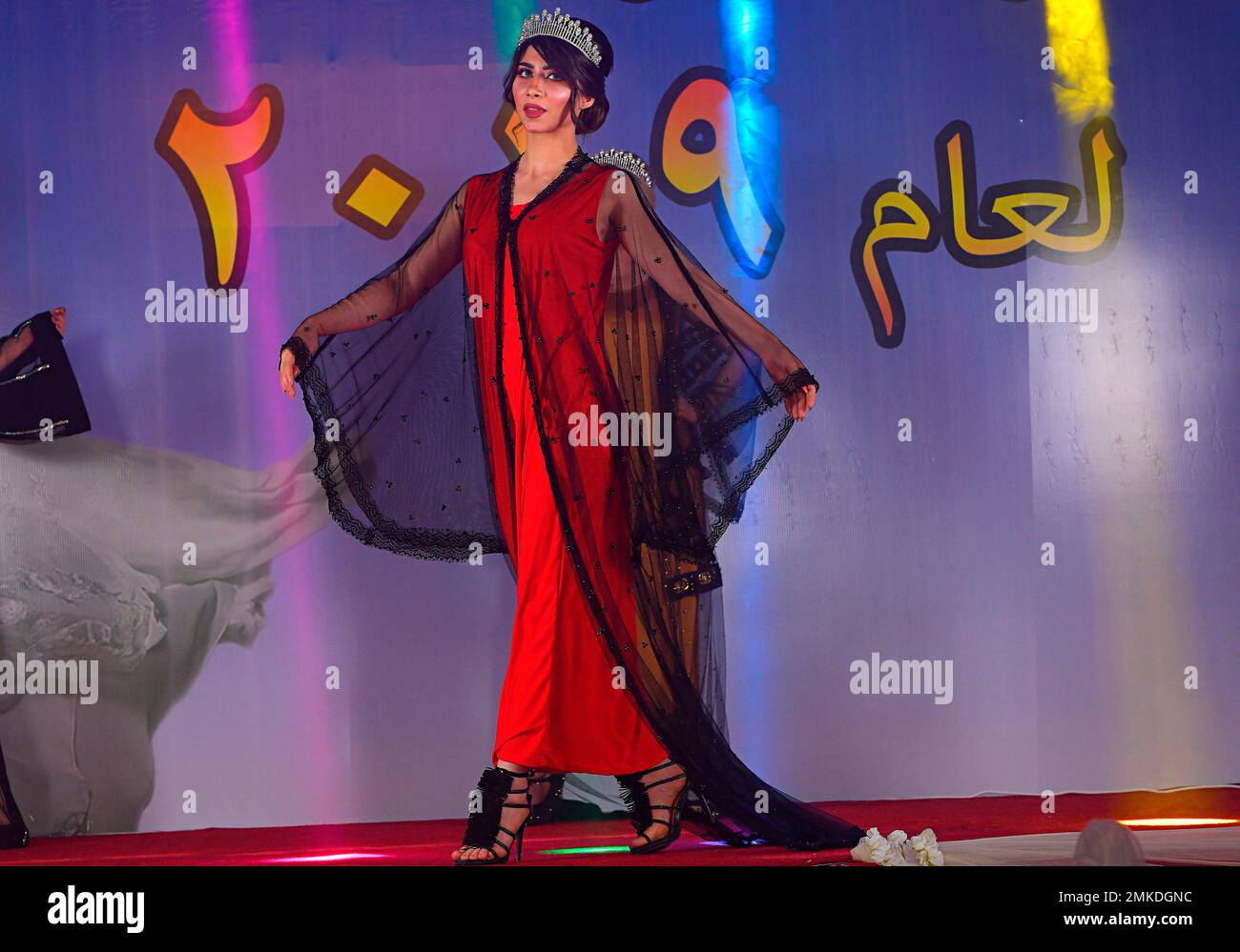 A model walks the catwalk, wearing in a traditional Iraqi folk costume ...