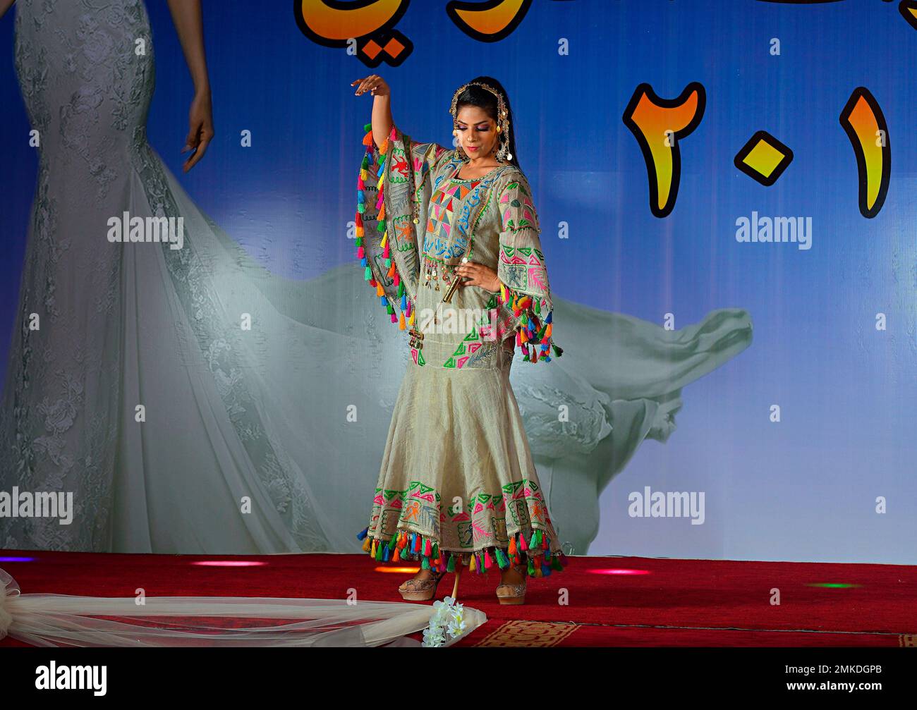 A model dressed in a traditional Iraqi folk costume walks the catwalk ...