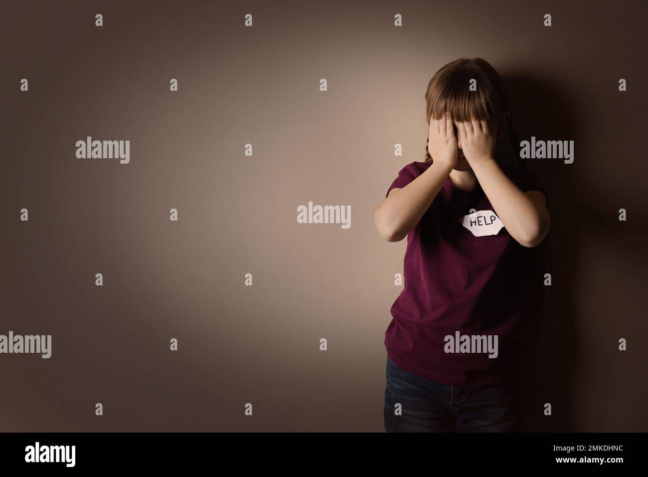 Little girl with sign HELP on beige background, space for text. Child ...