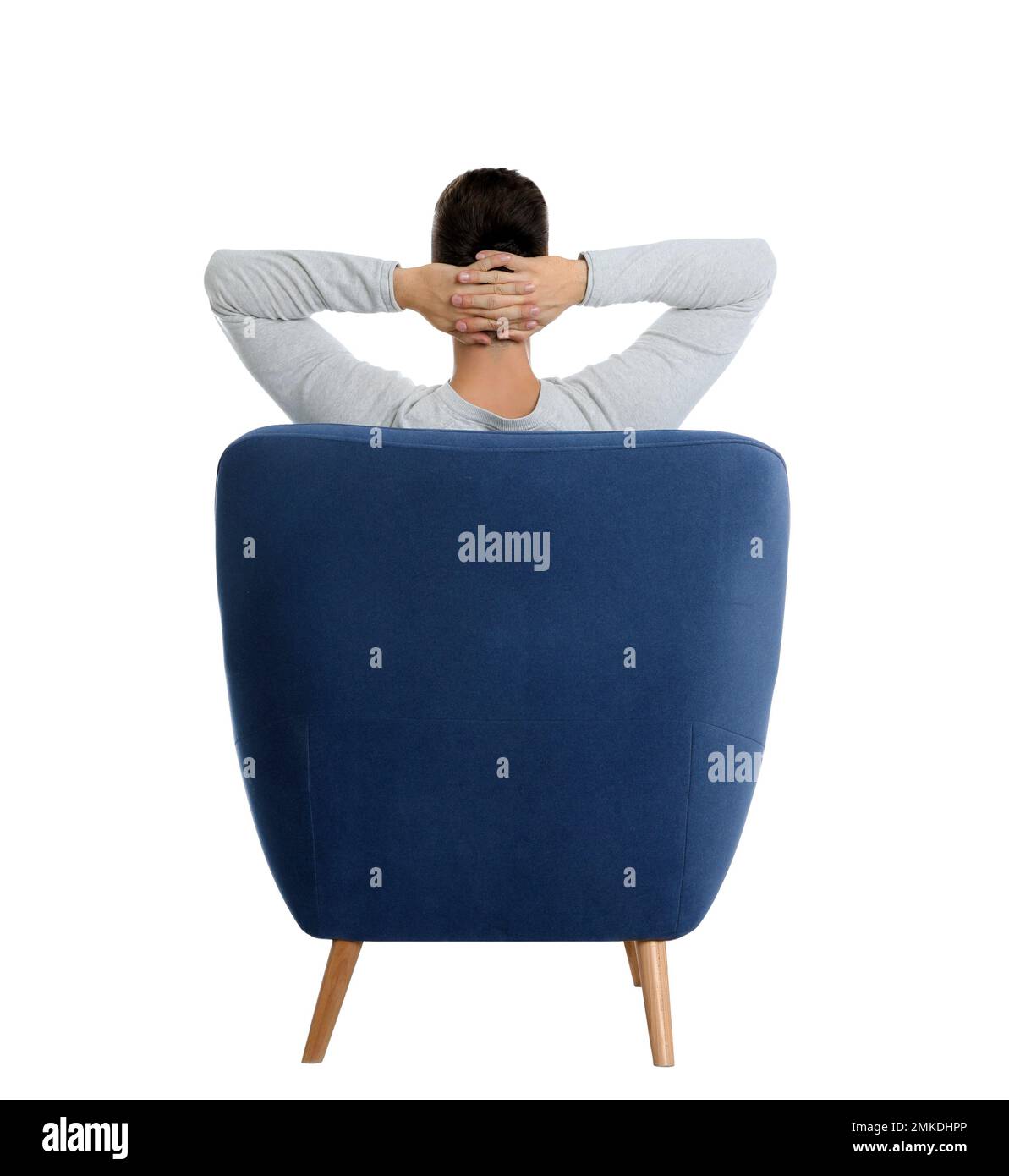 Young man sitting in armchair on white background, view from back Stock ...