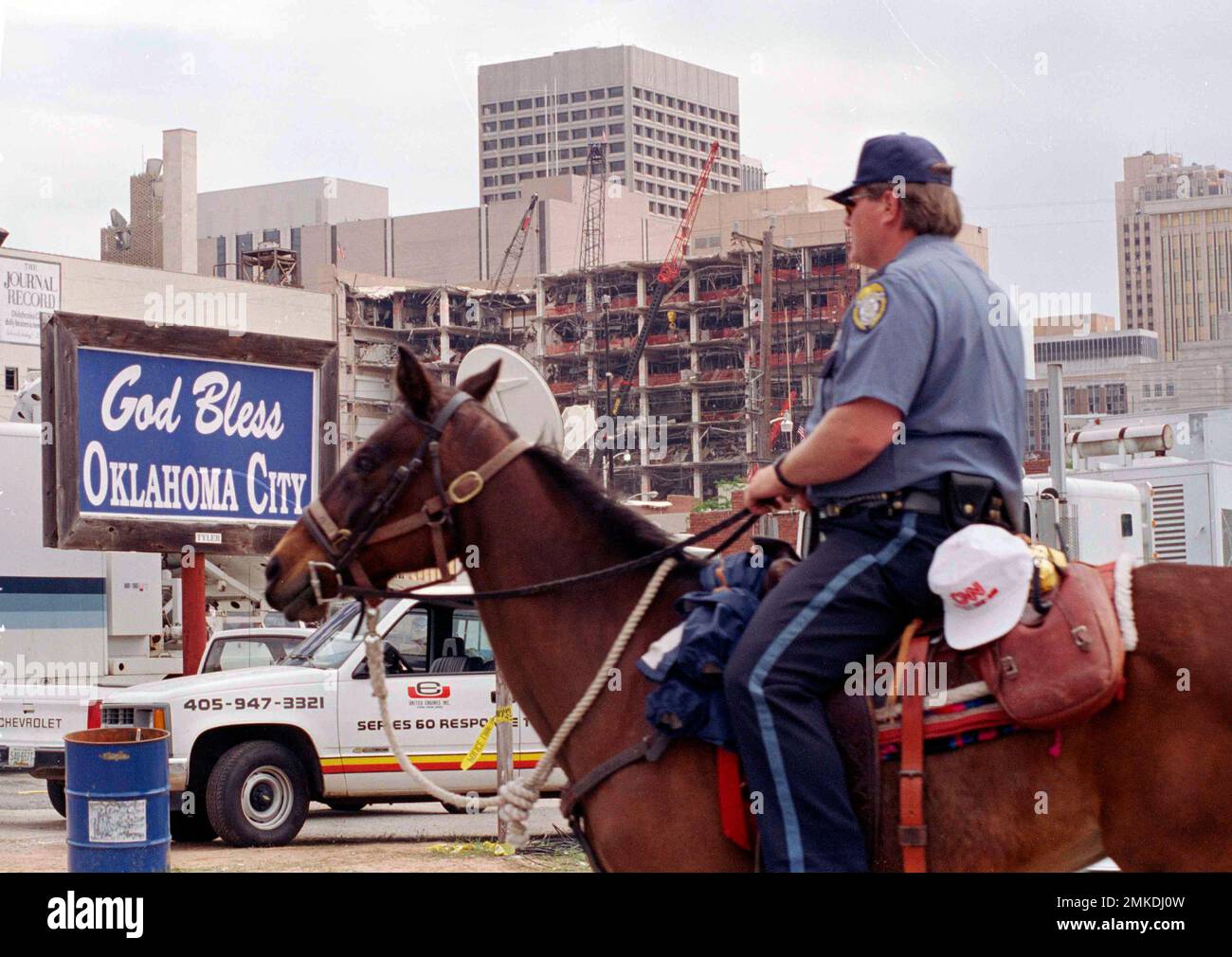 A mounted police officer approaches a billboard proclaiming support for ...