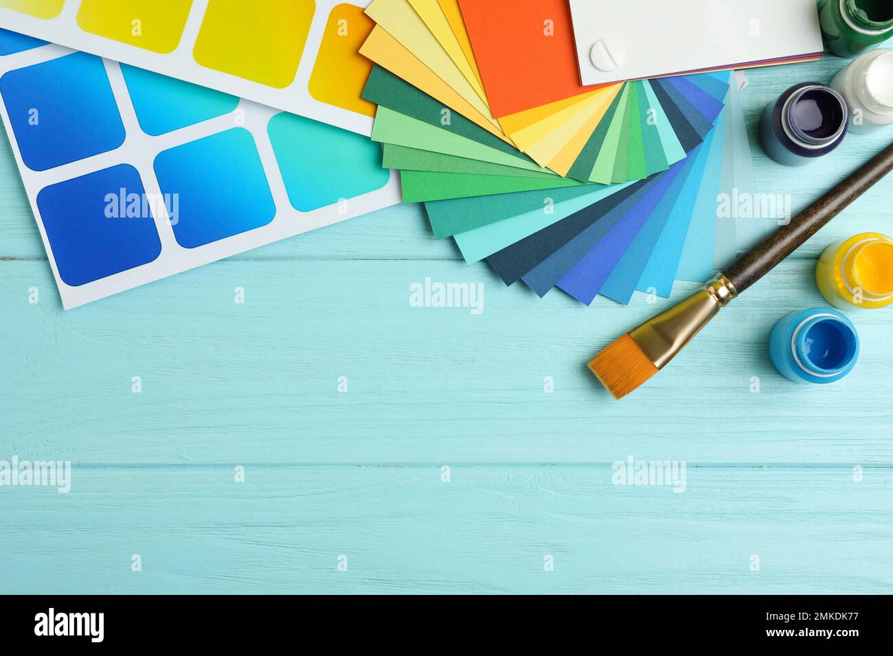 Flat lay composition with color palettes on light blue wooden ...