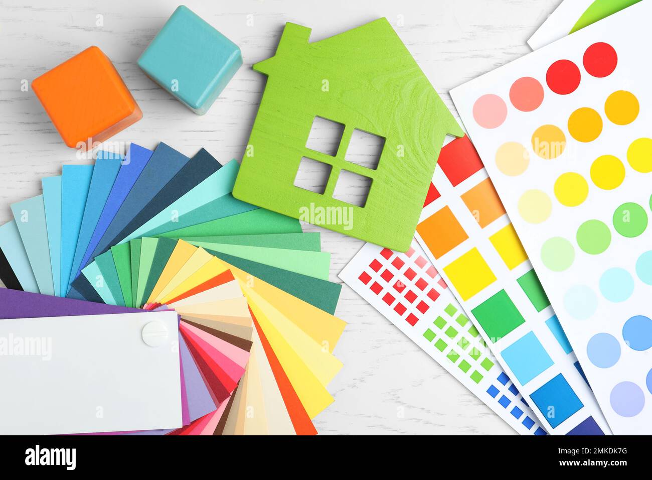 Flat lay composition with color palettes on white wooden background ...