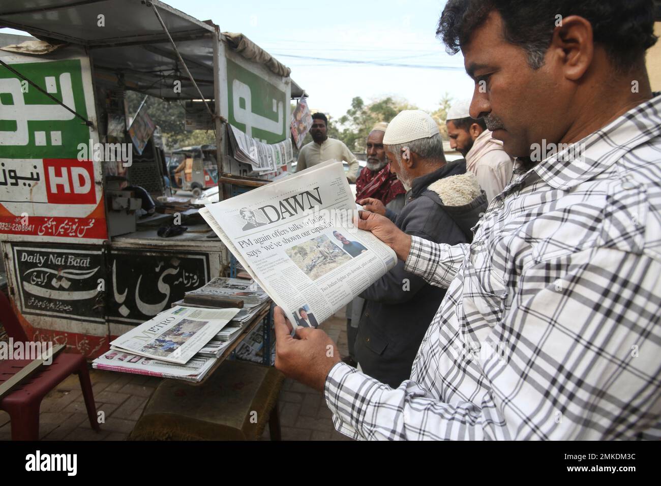 People read newspapers carrying headlines about India Pakistan tensions ...