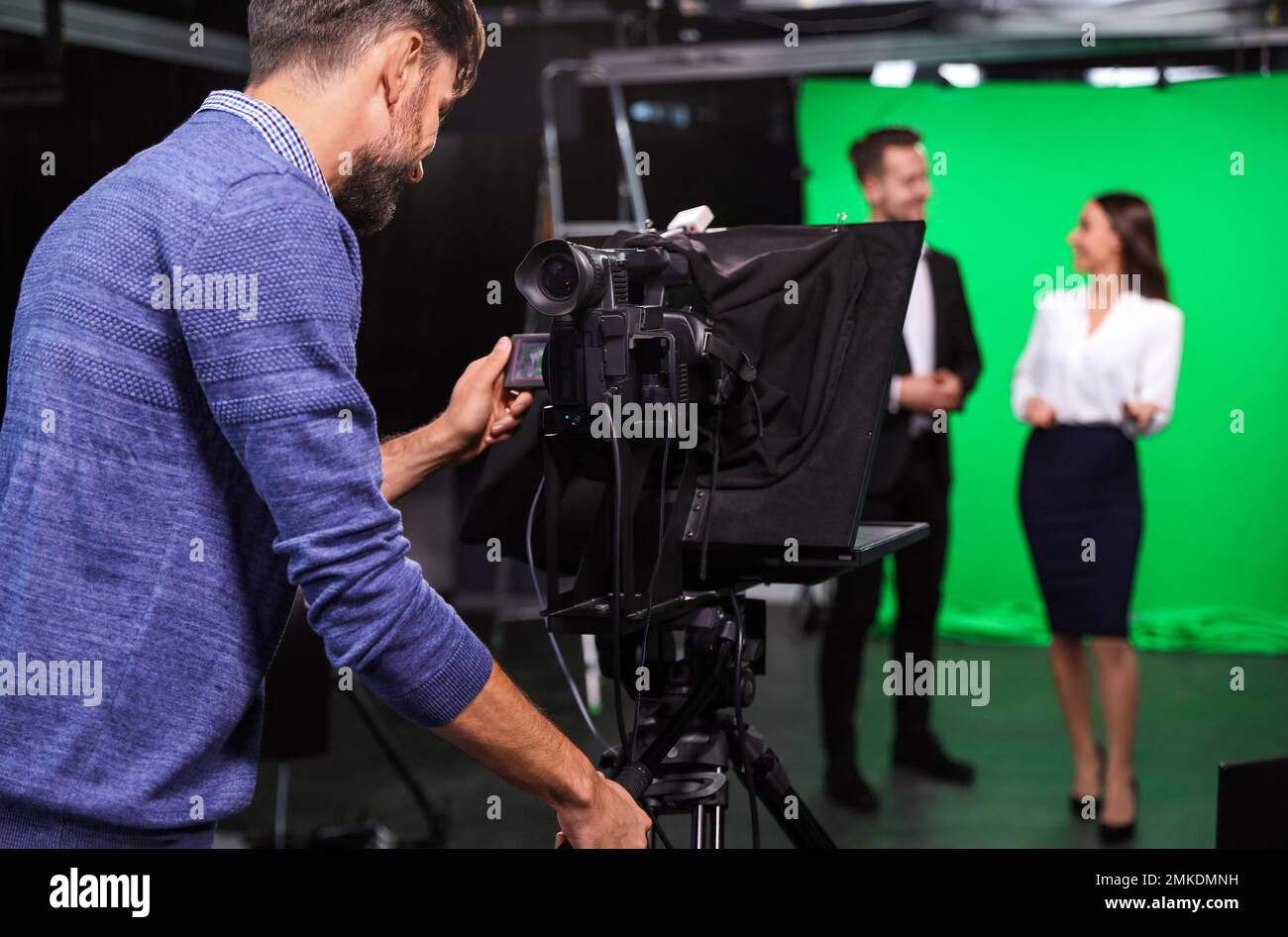 Presenters and video camera operator working in studio. News ...