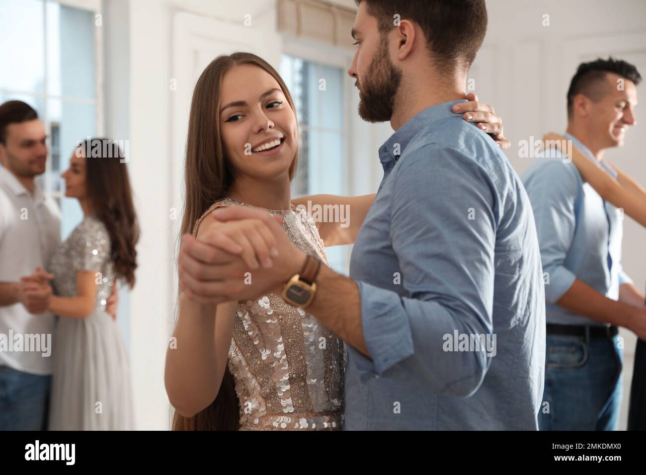 Lovely young couple dancing together at party Stock Photo - Alamy