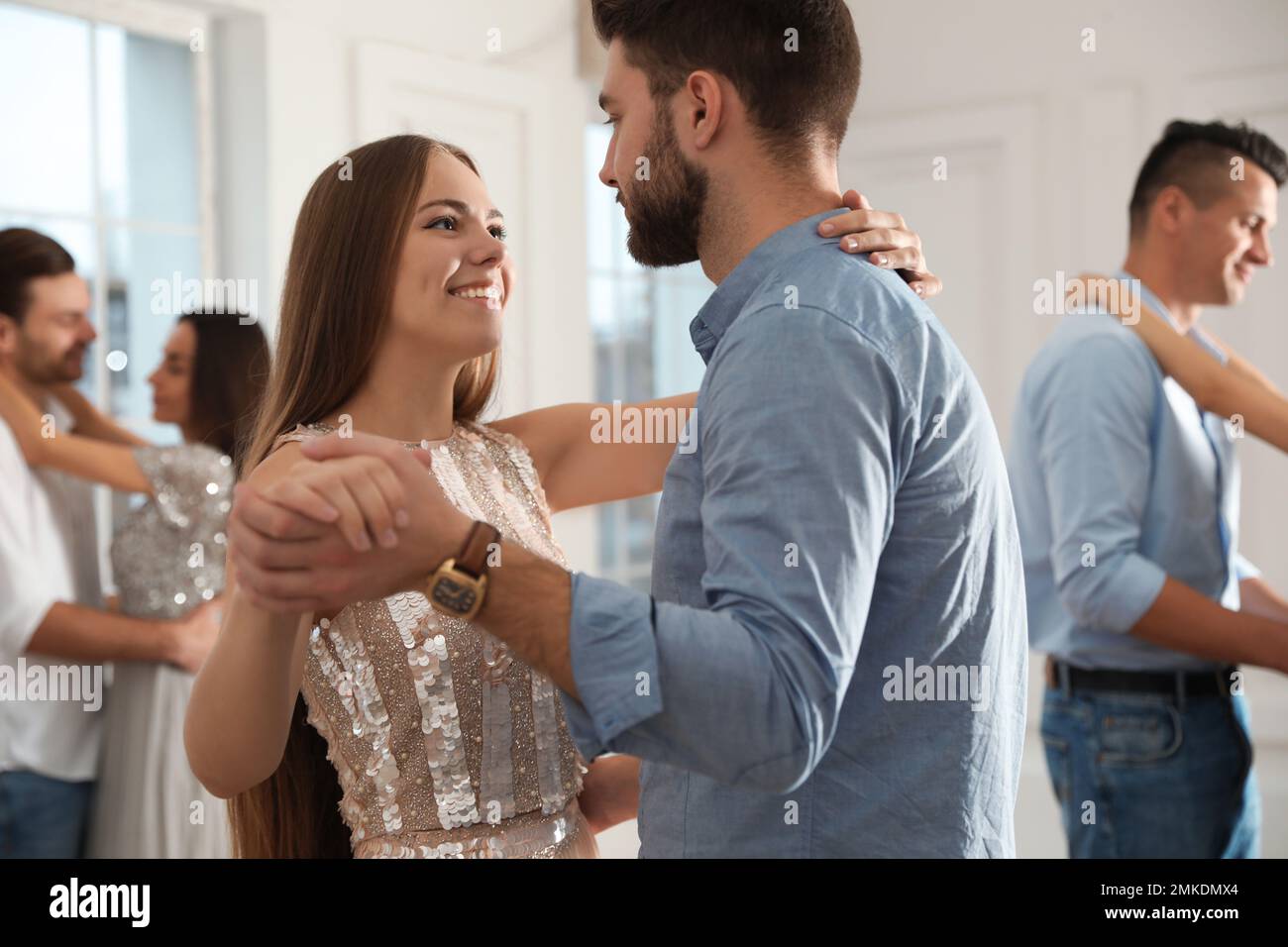 Lovely young couple dancing together at party Stock Photo - Alamy