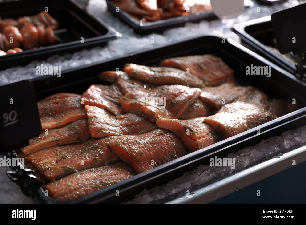 Fresh marinated fish in container on display, closeup Stock Photo - Alamy
