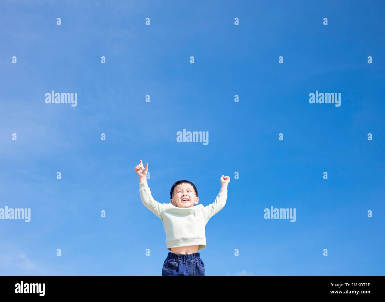 Happy boy reaching up to the sky Stock Photo - Alamy
