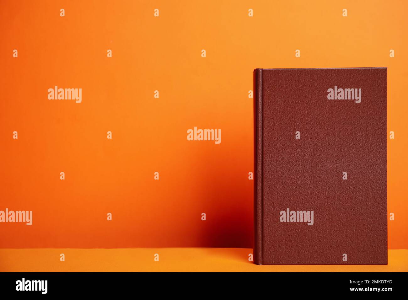 Hardcover book on orange background. Space for design Stock Photo - Alamy