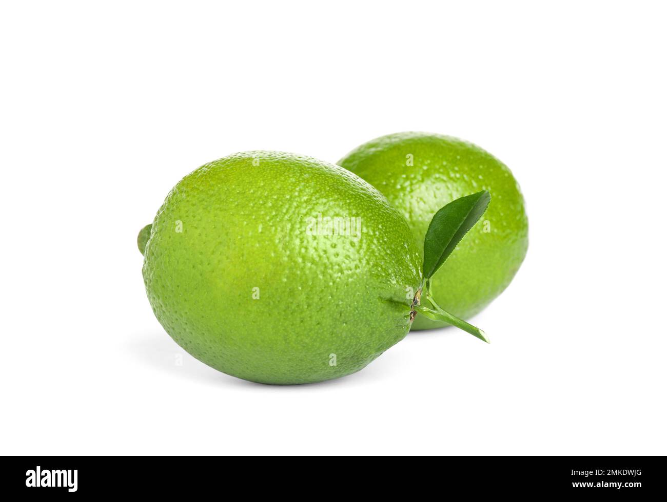Fresh ripe limes with green leaf isolated on white Stock Photo - Alamy