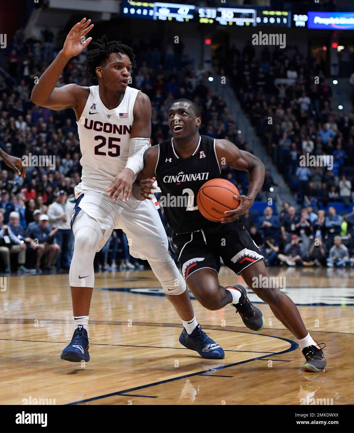 Cincinnati's Keith Williams drives to the basket as Connecticut's Josh ...