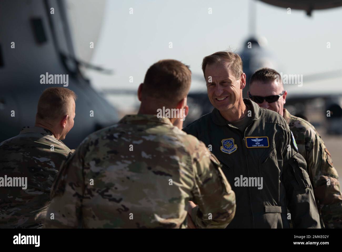 Maj. Gen. Corey Martin, 18th Air Force commander, right, shakes hands ...