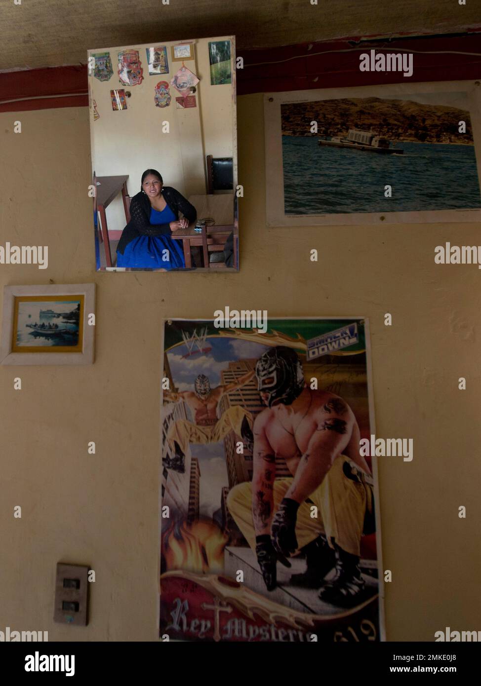 Veteran cholita wrestler Reyna Torrez is reflected in a mirror next to ...