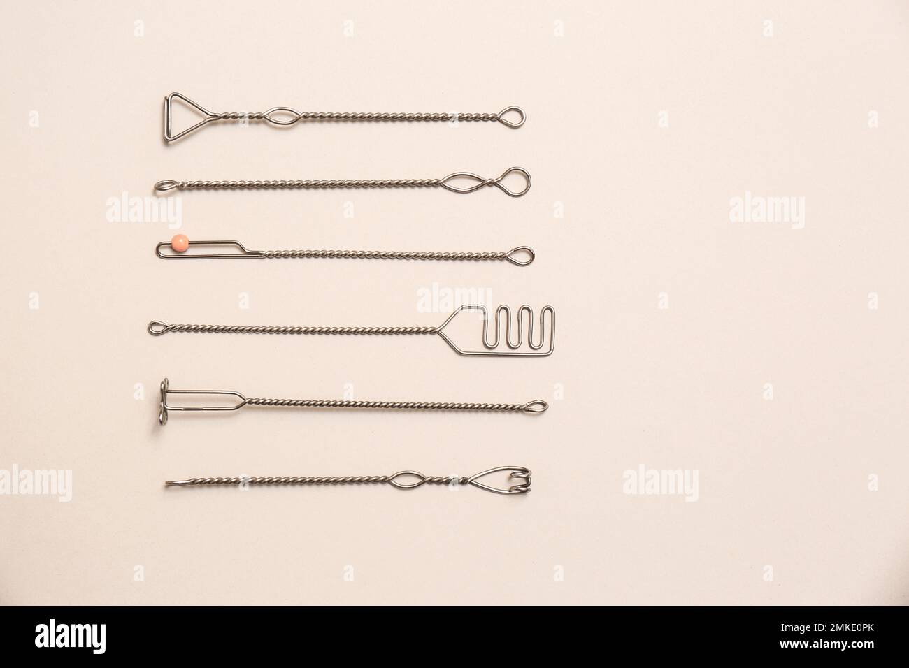 Set of logopedic probes for speech therapy on beige background, flat ...