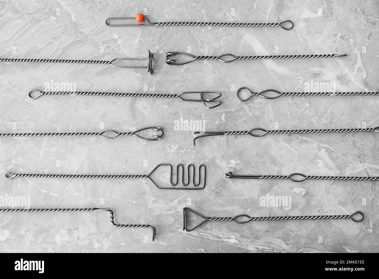 Set of different logopedic probes on marble table, flat lay. Speech ...