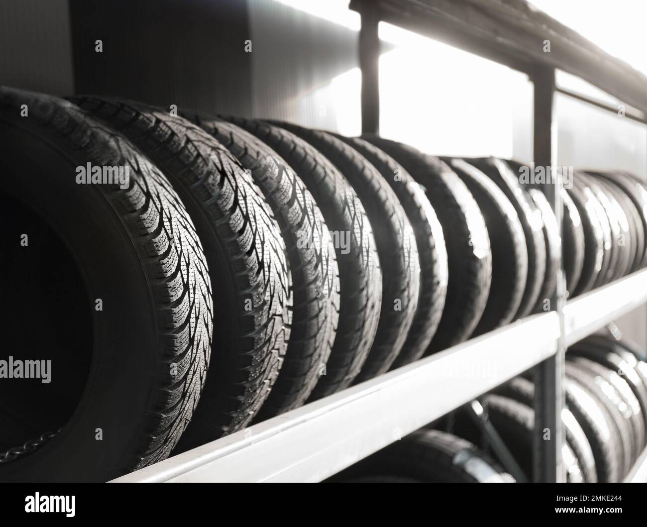 Tires on rack in car service workshop Stock Photo - Alamy