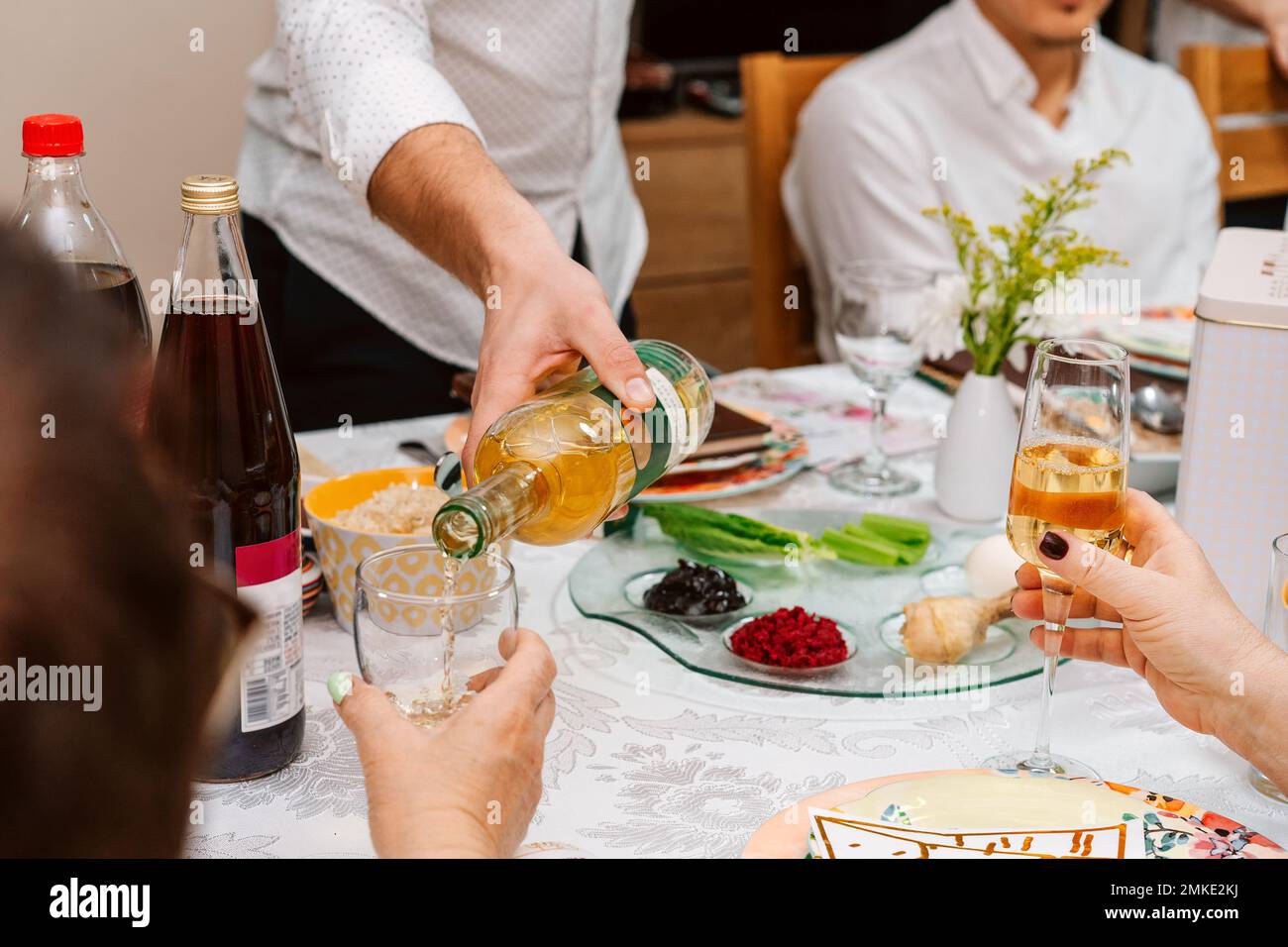Jewish family celebrating Passover at the table with traditional food ...